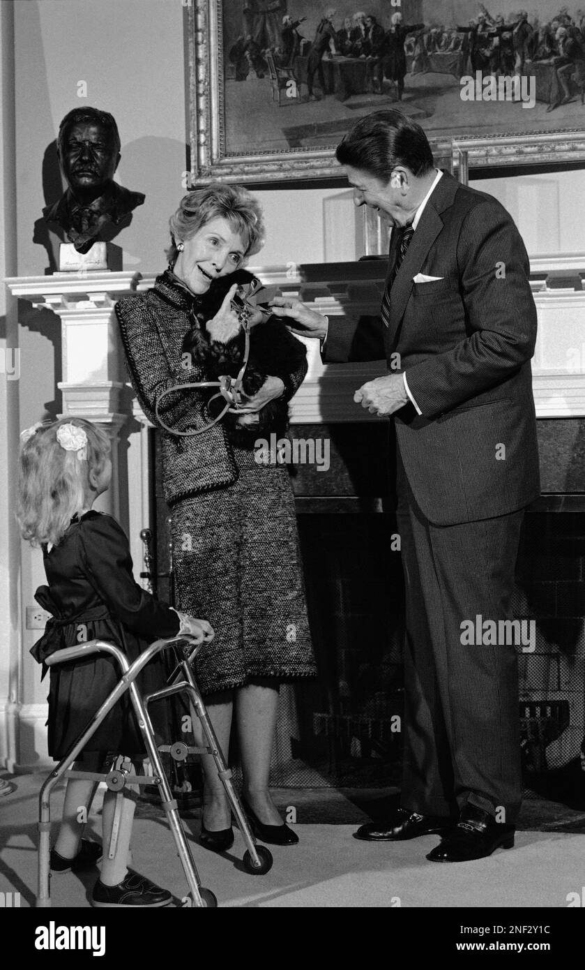 President Ronald Reagan and wife Nancy Reagan cuddle a nine-week-old ...