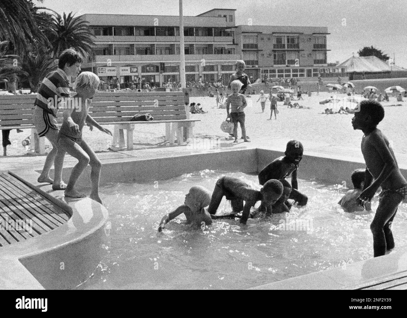 Children frolic in a small pool on the beach of this mostly German ...