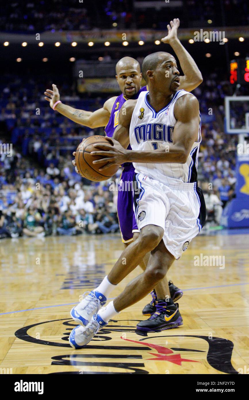 Orlando Magic's Rafer Alston (1) drives past Los Angeles Lakers' Derek ...
