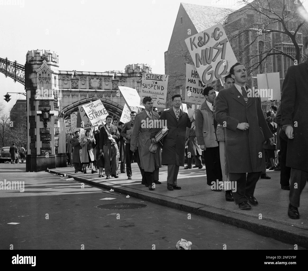 Placard-carrying students walk in picket line around buildings of main ...