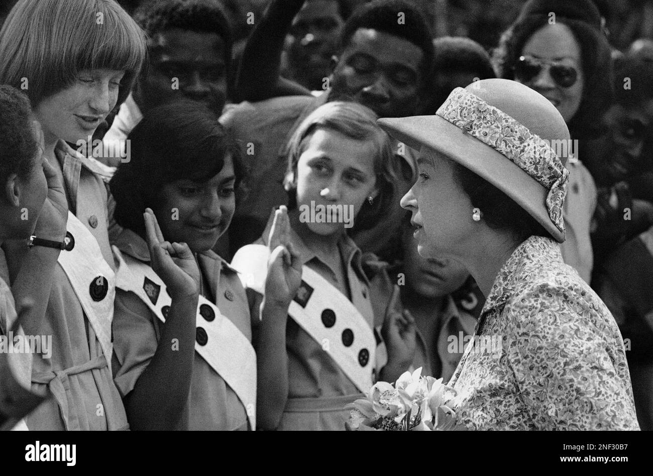Queen Elizabeth II talks with two English Girl Scouts saluting her ...