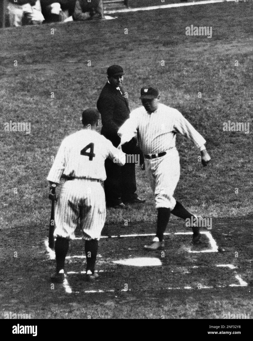 Babe Ruth crosses the plate with a run, date unknown. Welcoming him to ...