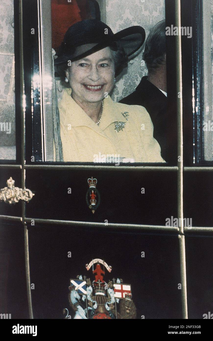 Britain's Queen Elizabeth II smiles from a carriage window as she ...