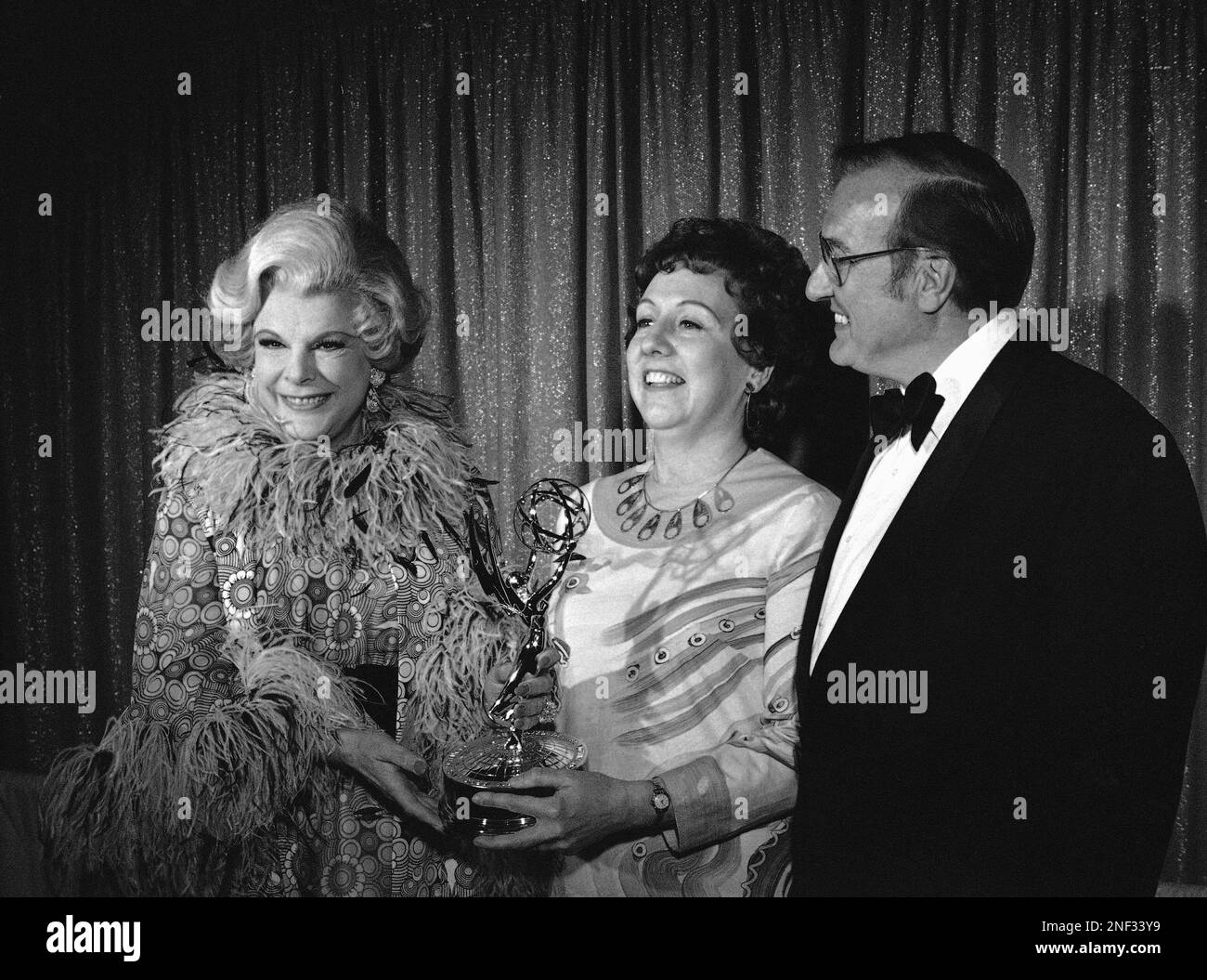 Actress Jean Stapleton, center, holds her “Emmy” after winning for her ...