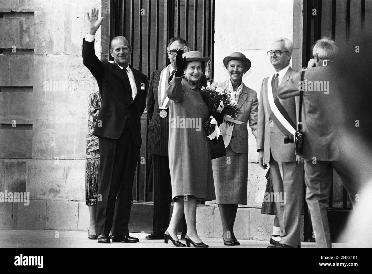 Queen Elizabeth II and her husband Duke of Edinburgh wave to the crowd ...