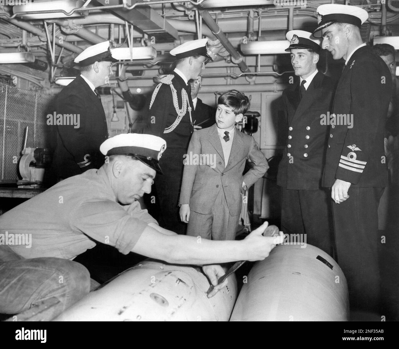 Charles, Prince of Wales, center, watches as Chief Petty Officer ...