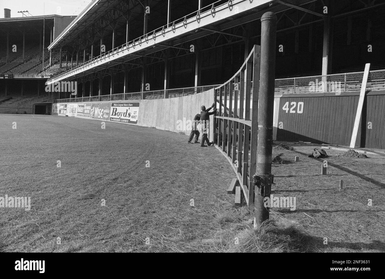 Workmen put up paneling of the new center field fence in Connie Mack ...