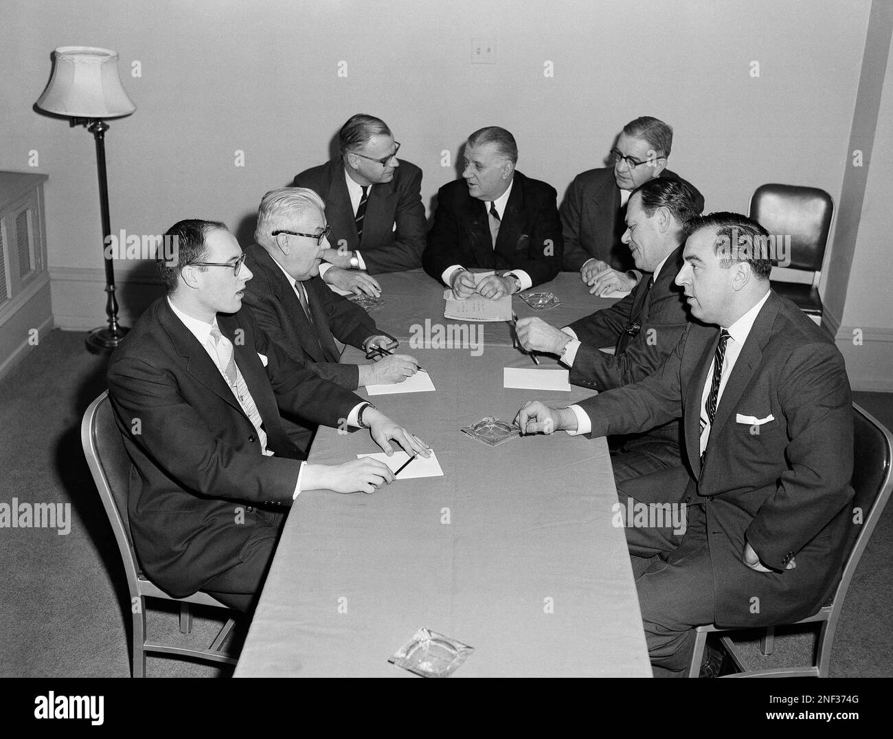 Bert Bell, commissioner of the NFL, center, discusses a proposed no ...