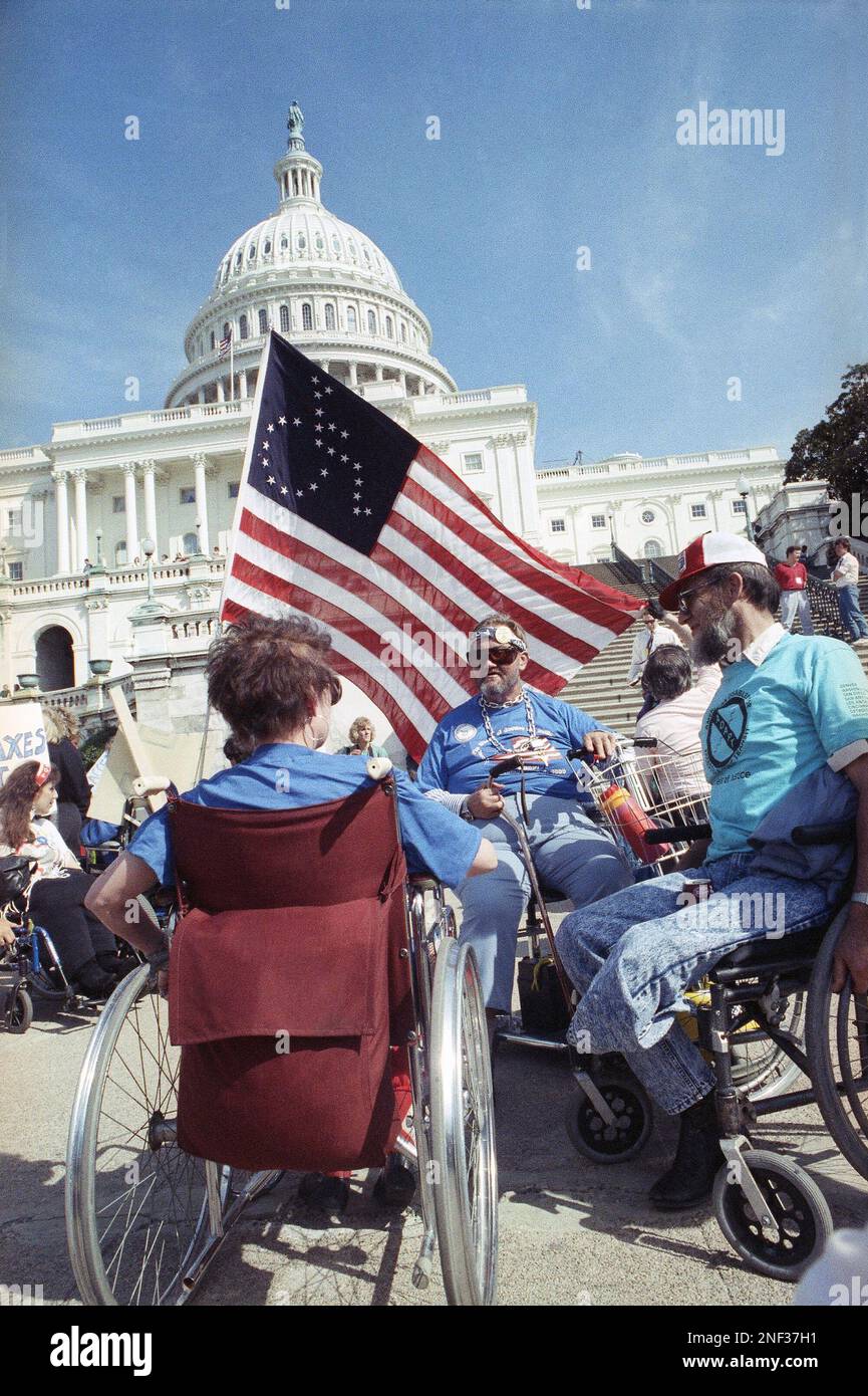 A group of handicapped people gather outside of the Capitol building on ...