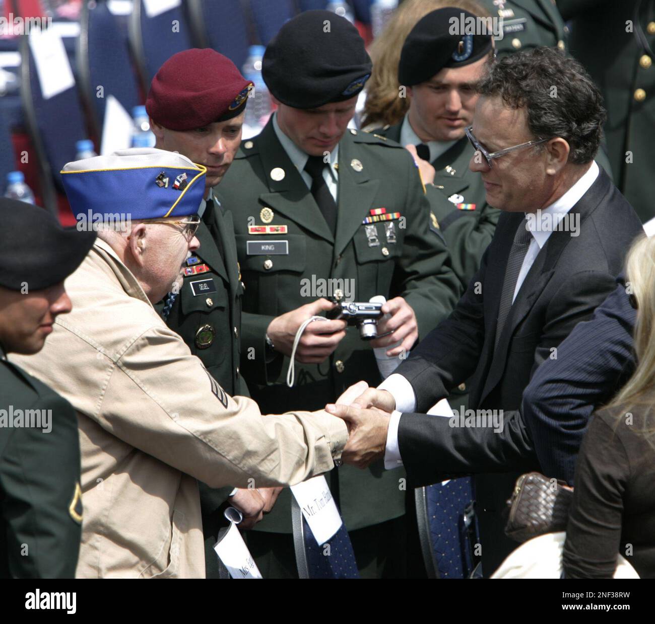 US movie star Tom Hanks, right, shakes hands with an unidentified US ...