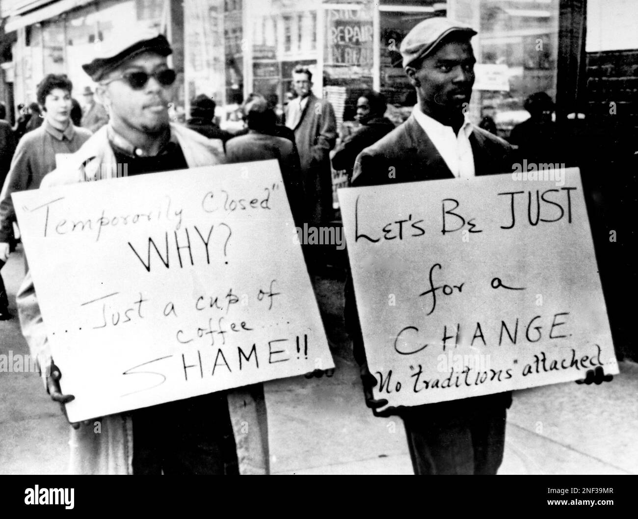 African Americans demonstrators carry picket signs along the main ...
