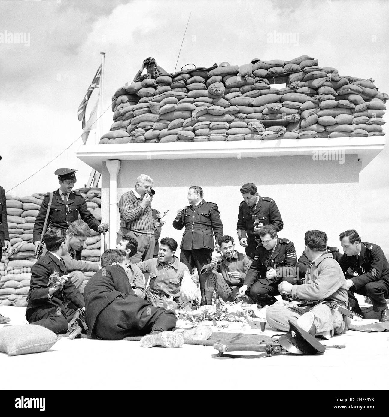 Greek Cypriot police and irregulars drink wine and eat olives to ...