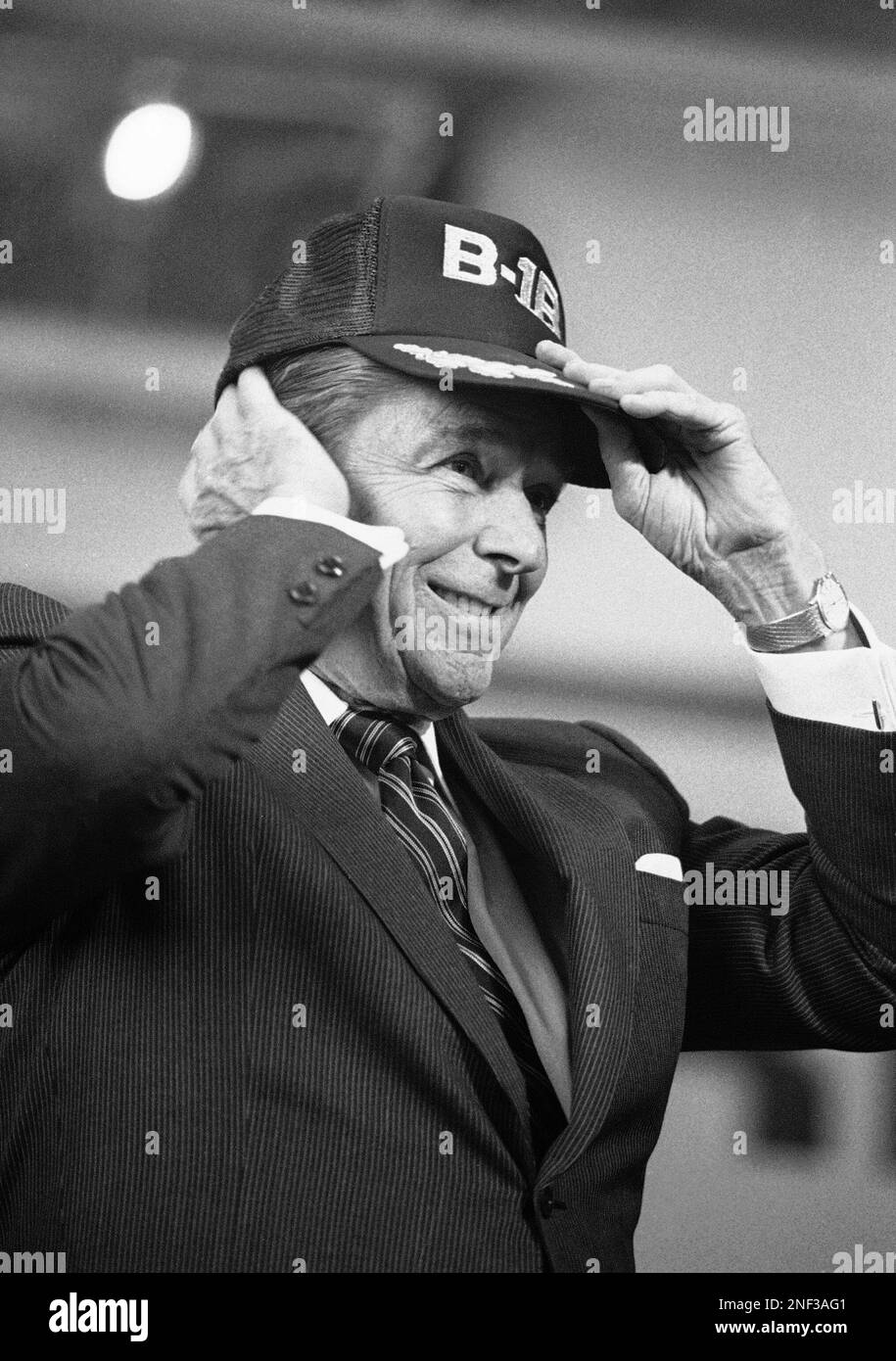 President Ronald Reagan puts on a B-1B bomber hat presented him at the ...