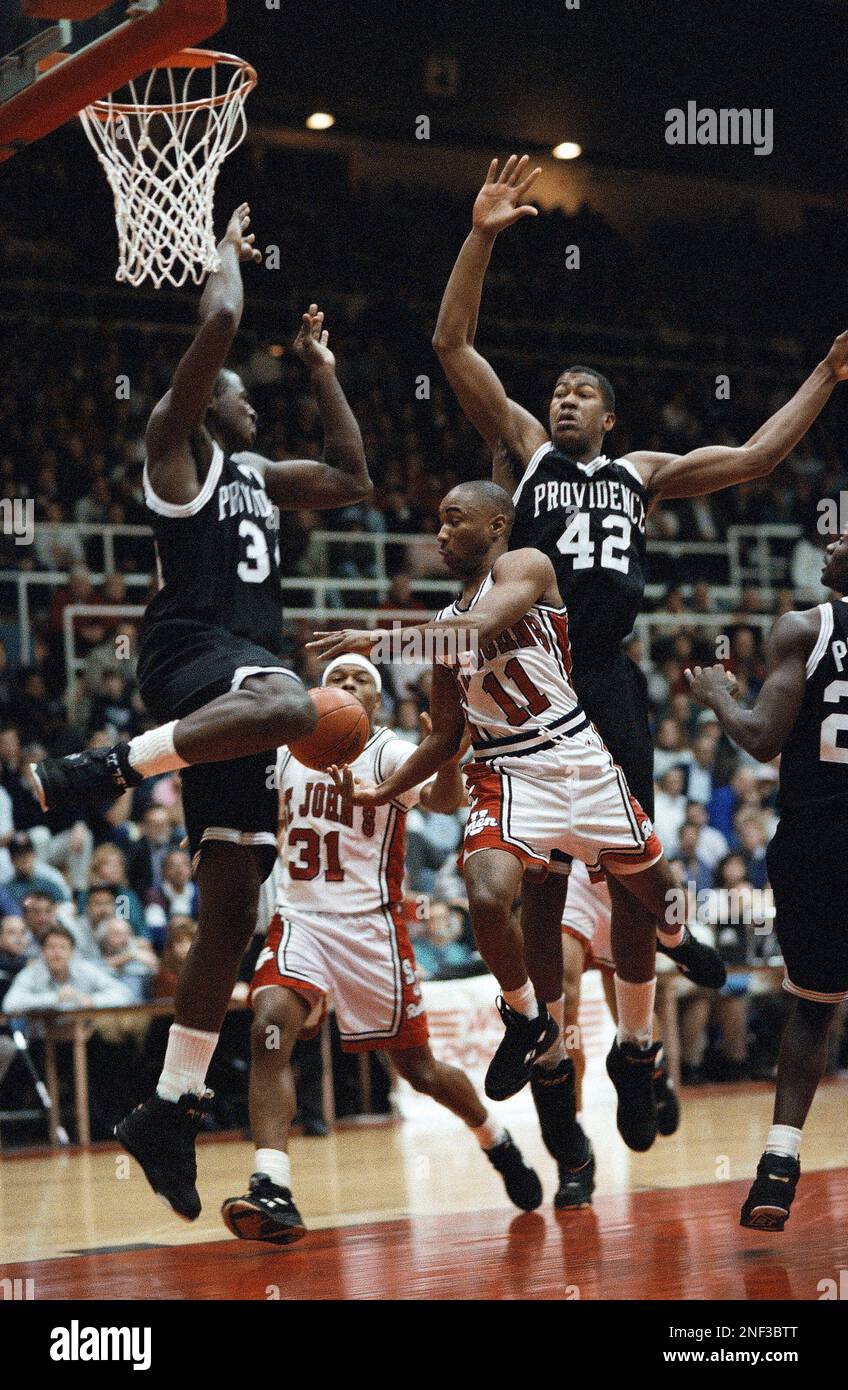 St. John’s David Cain (11) tries to score between Providence’s Tony ...