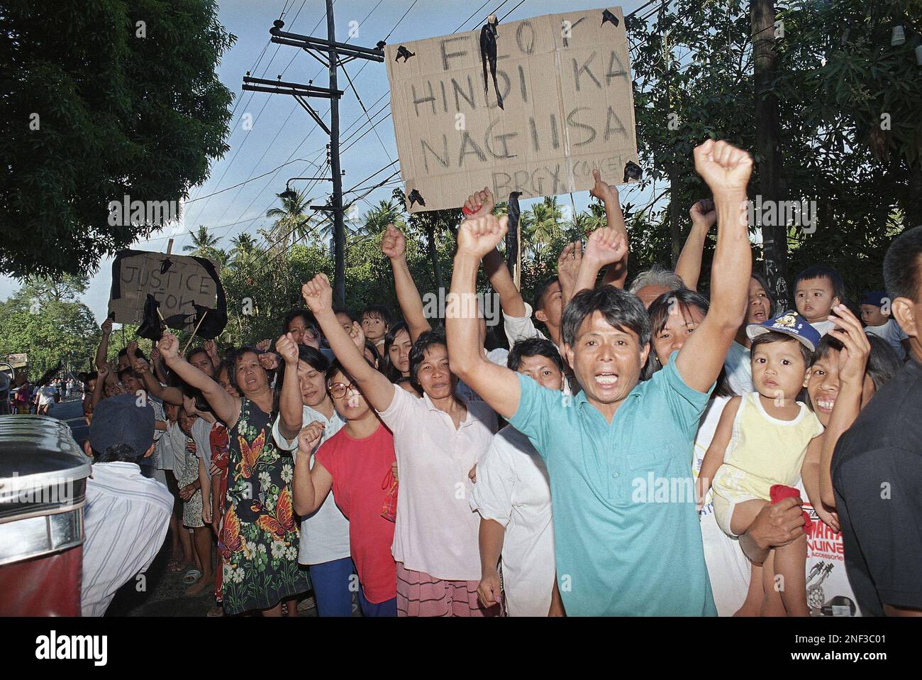 Residents clenched their fists and shout slogans asking for justice ...