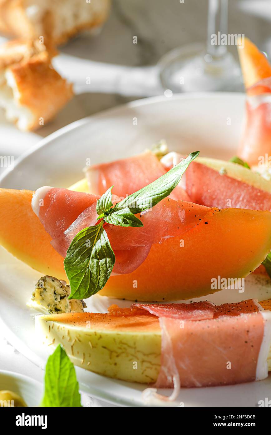 melon with parma and cheese on a marble backgroundphoto, white wine ...