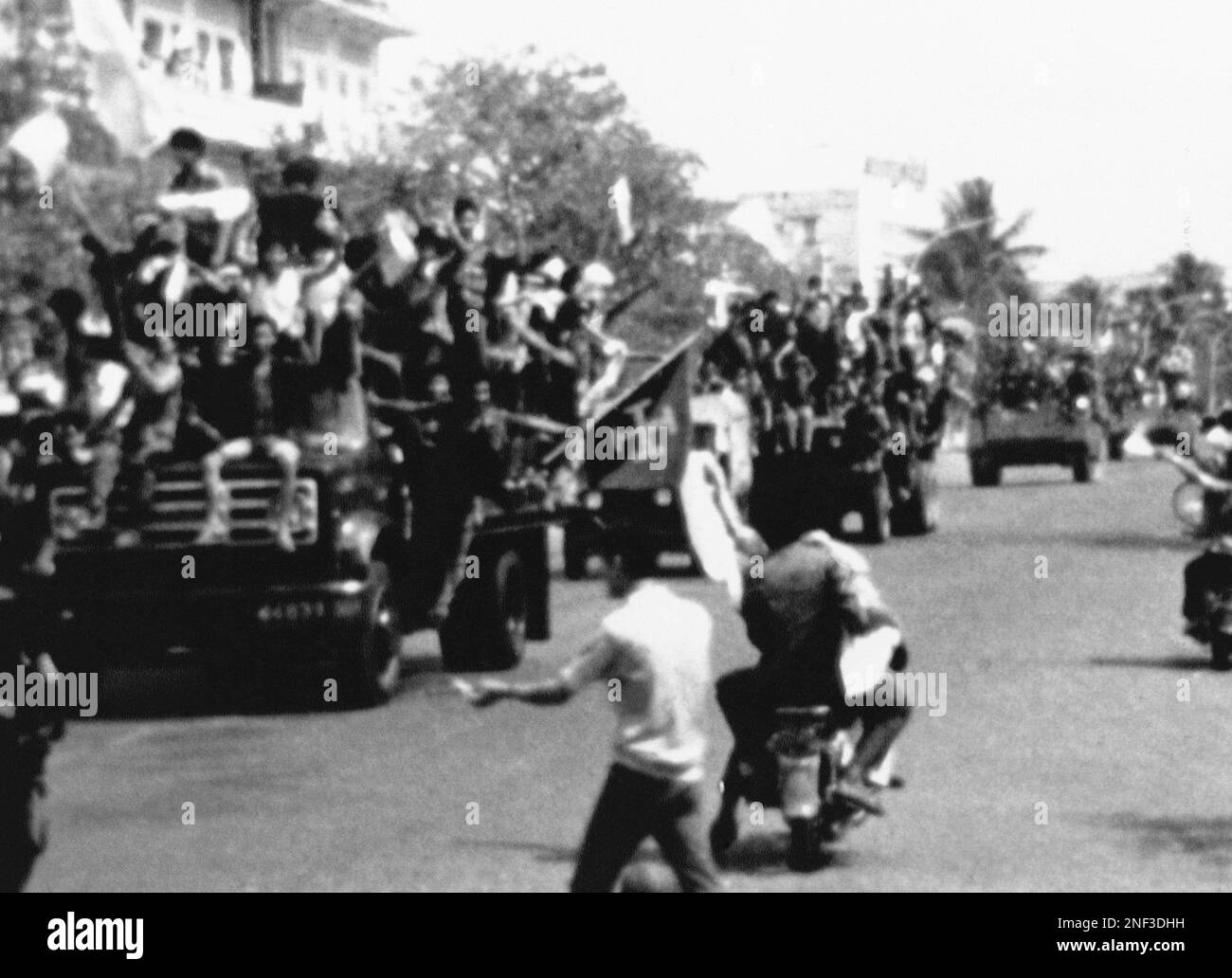 Flag waving and jubilating Red Khmer soldiers enter the city of Phnom ...