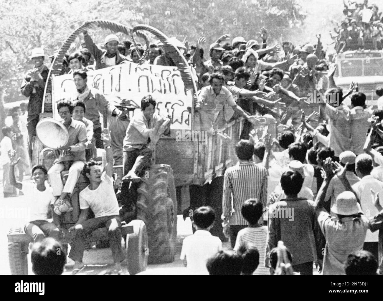 Unidentified persons wave to each other in Poipet, on the Cambodian ...
