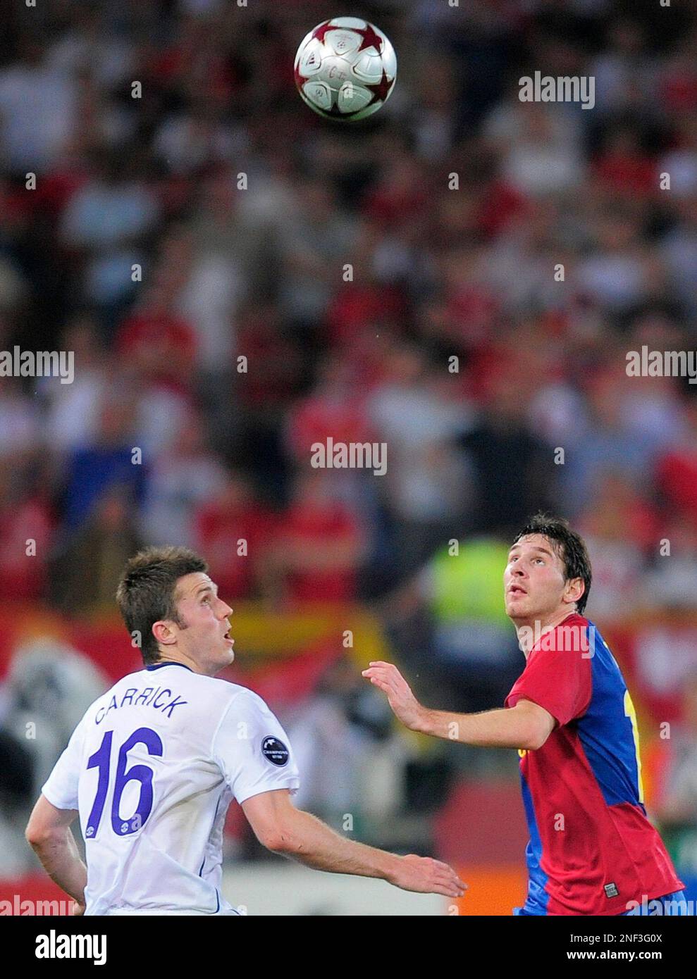 Manchester United's Michael Carrick, left, and Barcelona's Lionel Messi ...