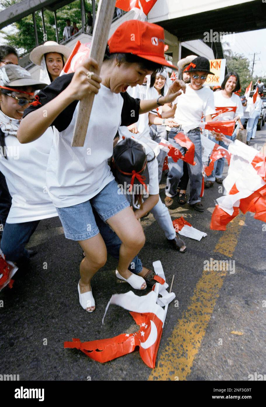 Filipino overseas contract workers stomp on Singaporean flags during a ...