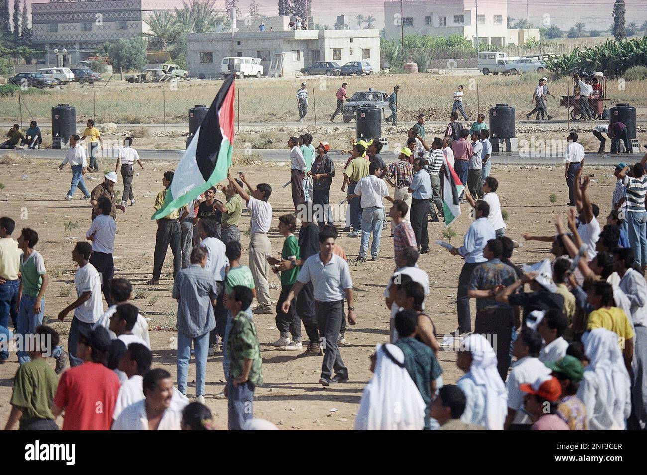 Scattered crowd wave hands and flags as the helicopter of PLO Chairman ...