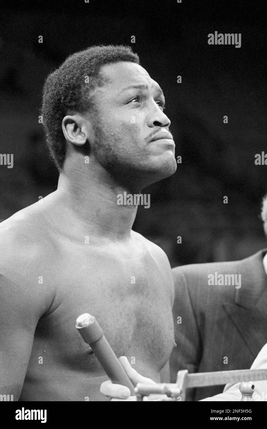 Joe Frazier, boxing heavyweight king intently peers at reading on scale ...