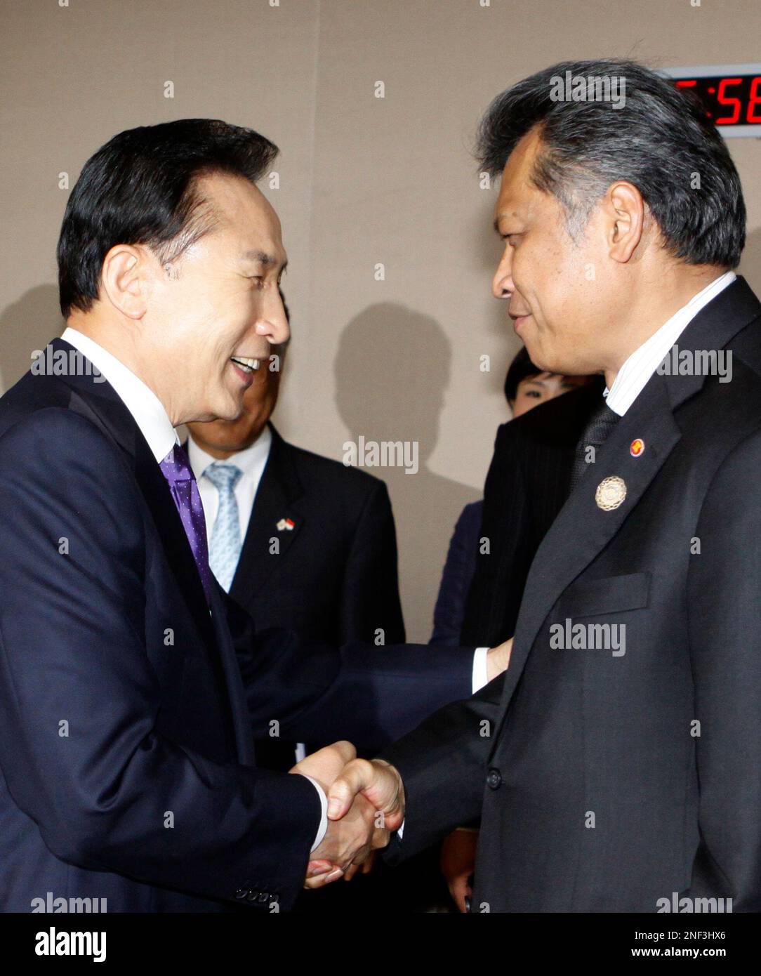 South Korean President Lee Myung-bak, left, greets Surin Pitsuwan ...
