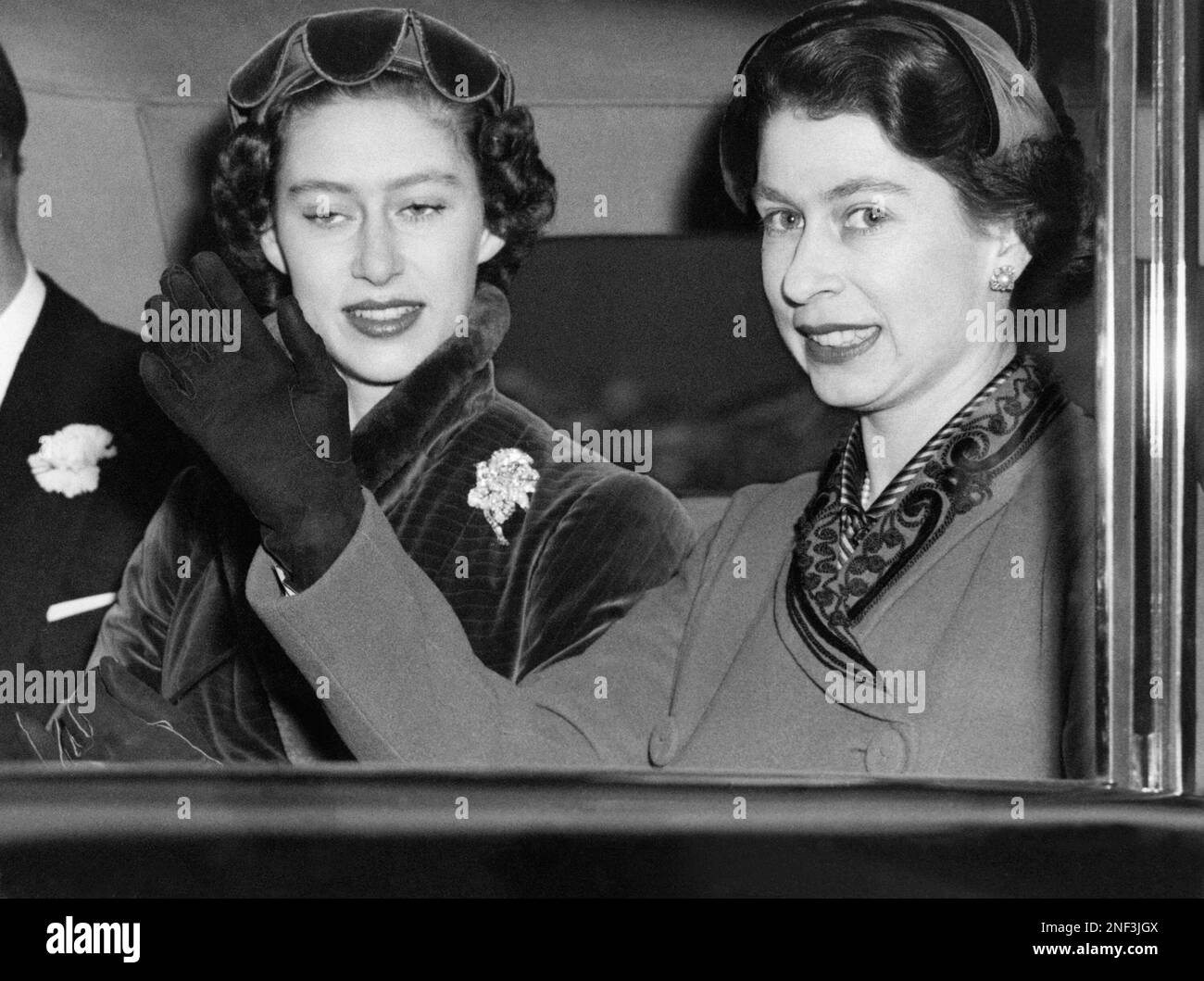Princess Margaret (left) sits beside her smiling sister, Queen Elizabeth II, in car after ...