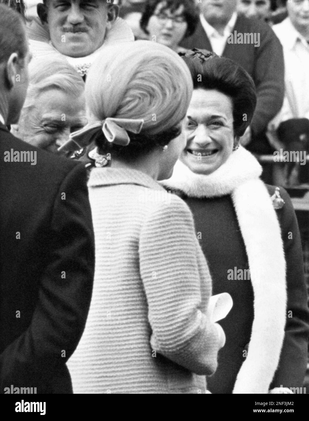 Queen Elizabeth II of England, back to camera, talks with her uncle ...