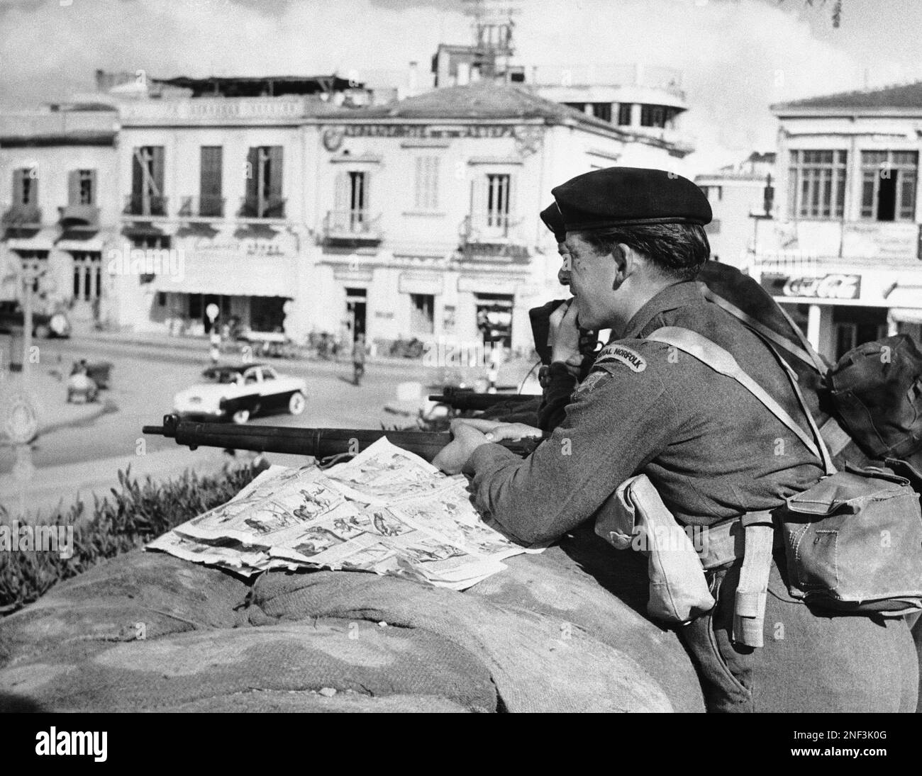 Soldiers of the British Royal Norfolk Regiment have guns ready as they ...