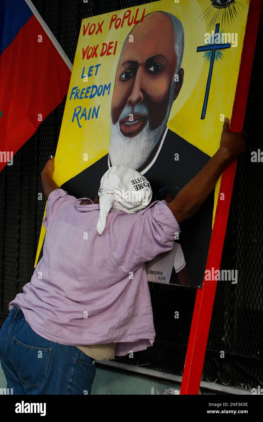 An unidentified Haitian woman stands outside the Veye Yo Political ...