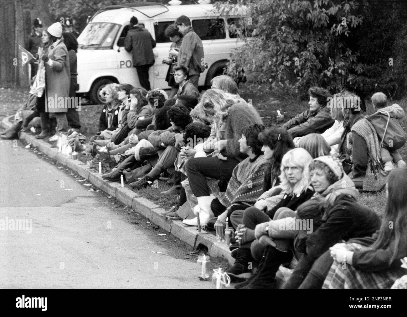 Women, some with their children, sit in protest outside the U.S. Air ...