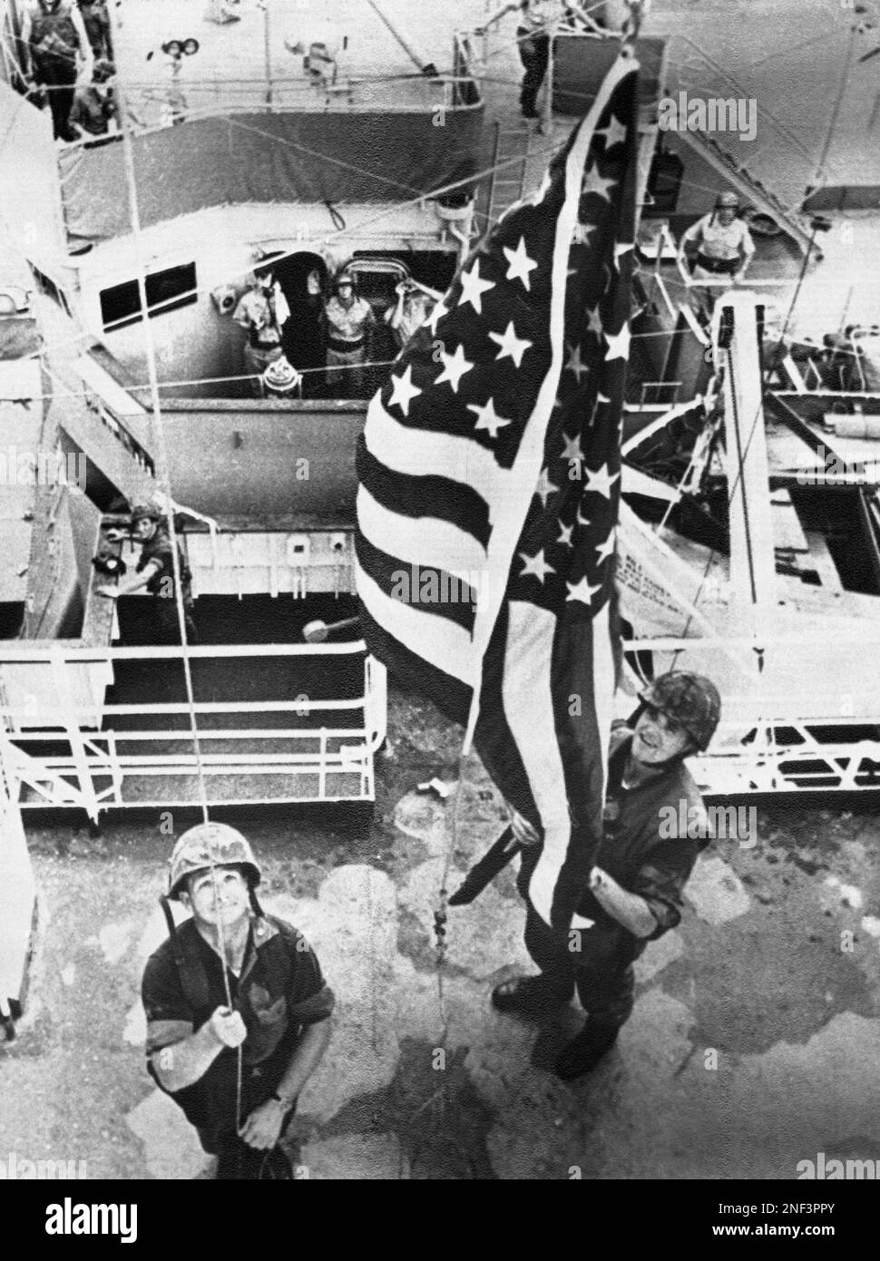 Marine Major Ray E. Porter, left, and Captain Walt Wood raise the ...