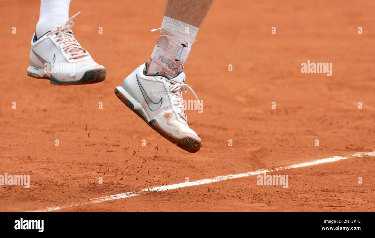 The feet of Britain's Andy Murray are seen as he serves the ball to ...