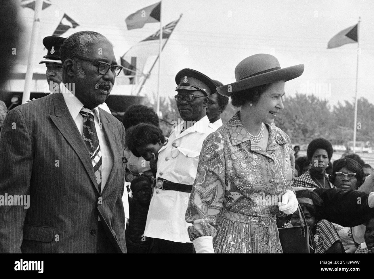 Britain's Queen Elizabeth II leaves her yacht in Nassau harbor escorted ...