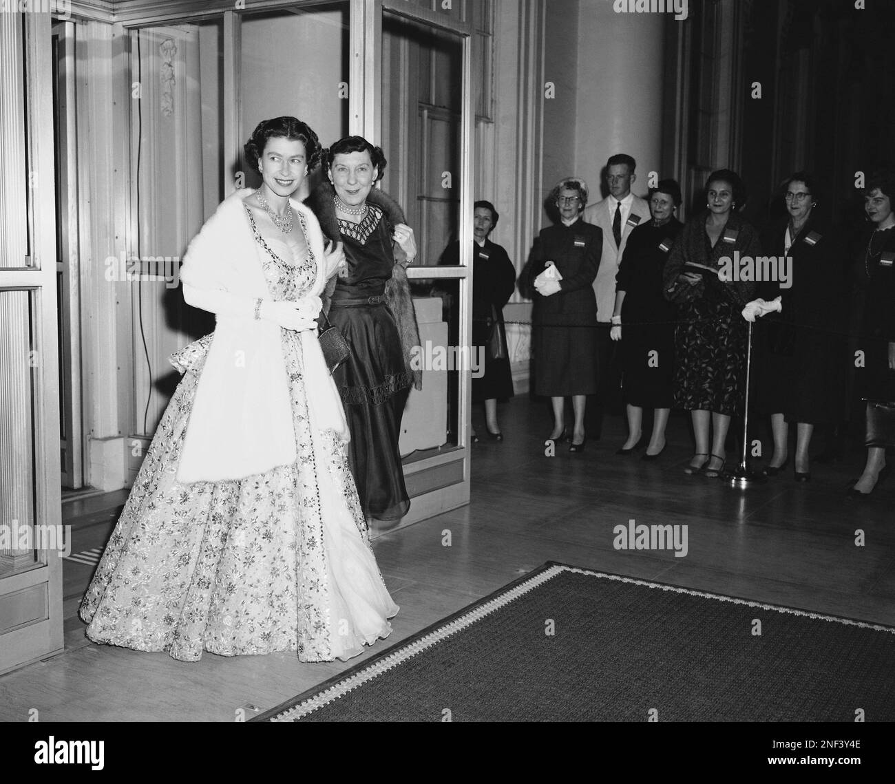 Queen Elizabeth II, sparkling in a lime green evening gown, poses at ...