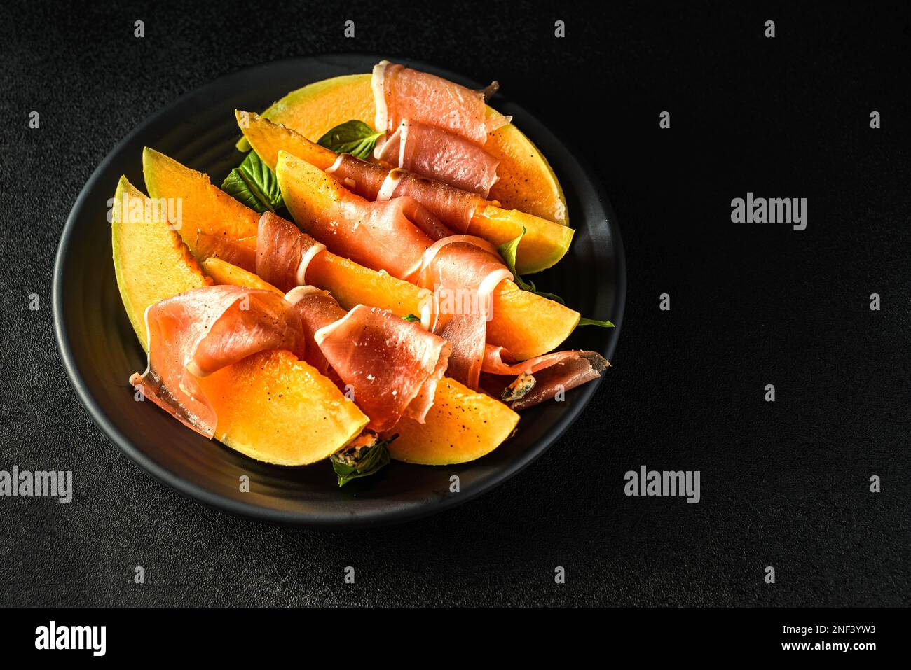 melon with parma on a dark background. High quality photo Stock Photo ...