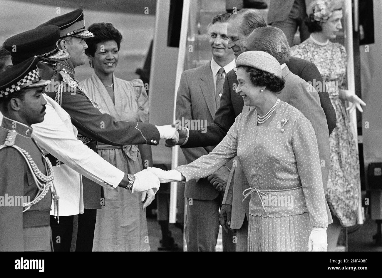 Britain's Queen Elizabeth II and the Duke of Edinburgh are watched by ...