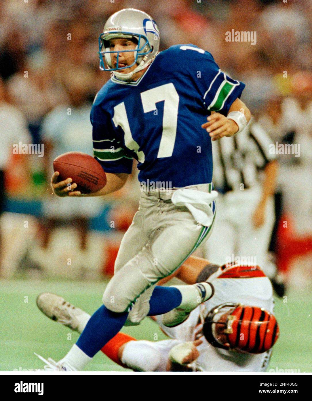 Seattle's quarterback Dave Krieg steps away from a Cincinnati defender ...