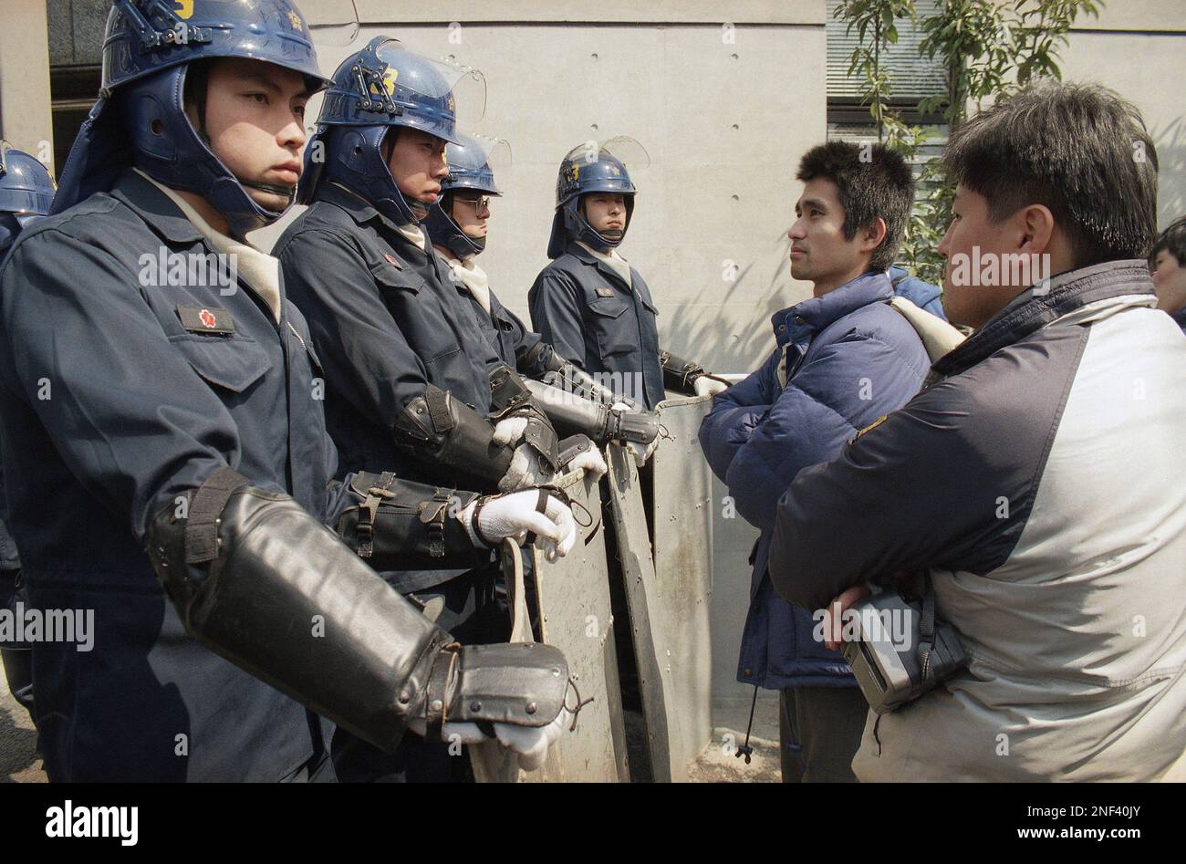 Tokyo riot police and members of the Aum Supreme Truth religious sect ...