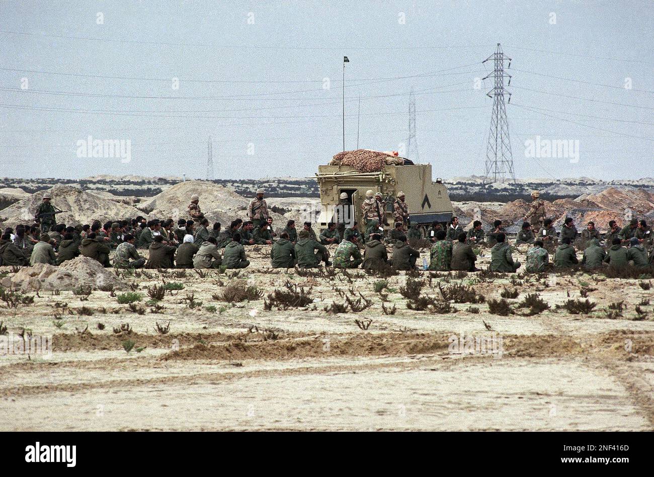 Saudi troops stand guard over Iraqi prisoners, Sunday, Feb. 24, 1991 in ...