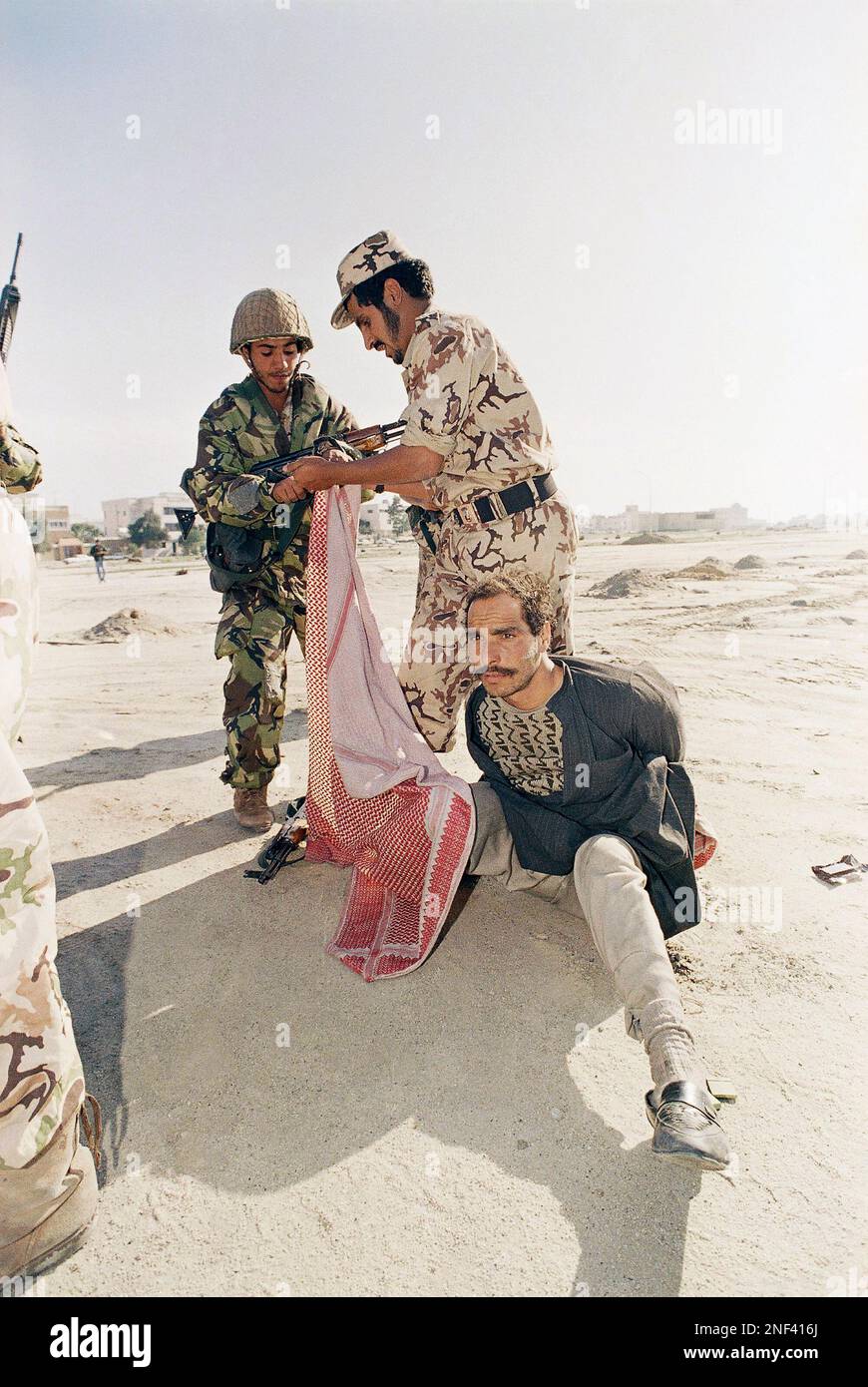 Kuwaiti army soldiers check the markings on the scarf taken from a ...