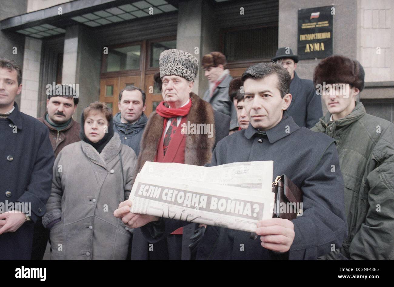 An unidentified ethnic Chechen displays the front page of the daily ...