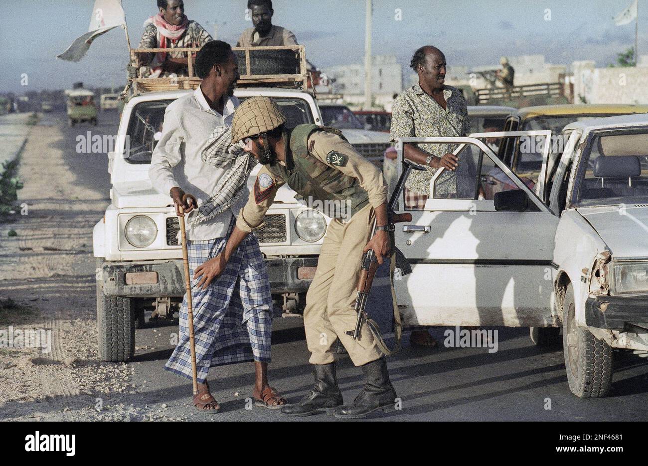 A Pakistani solder searches a Somali man for weapons during a routine ...