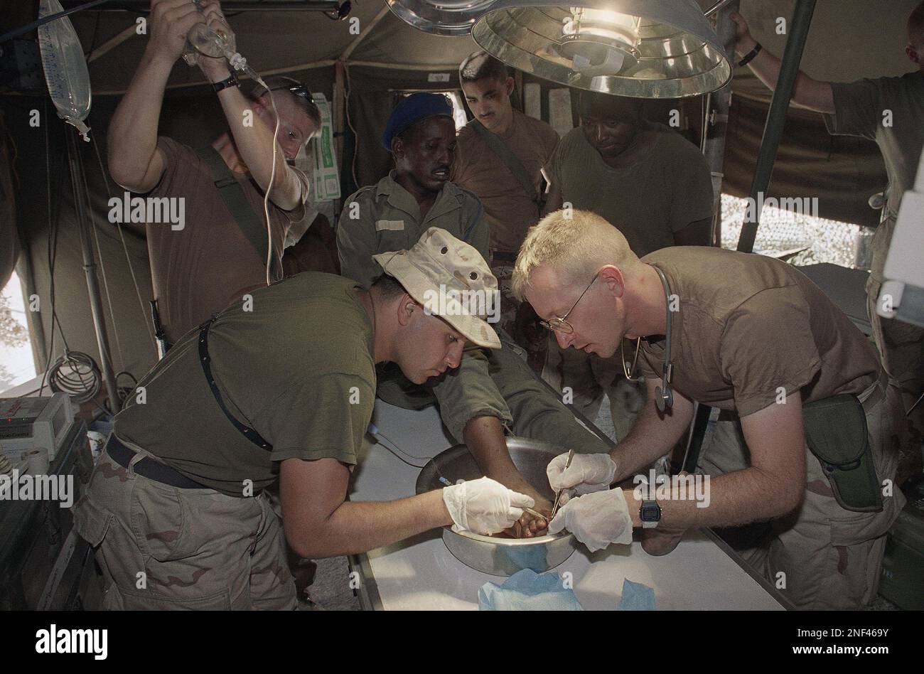 U.S. Navy physician Lt. Curtis Andersen, right, attends to a Somali ...