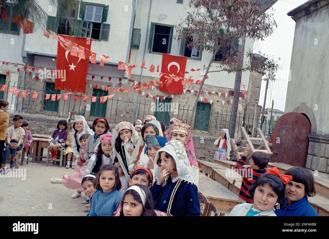 Turkish children, dressed in their national dresses, are signing and ...