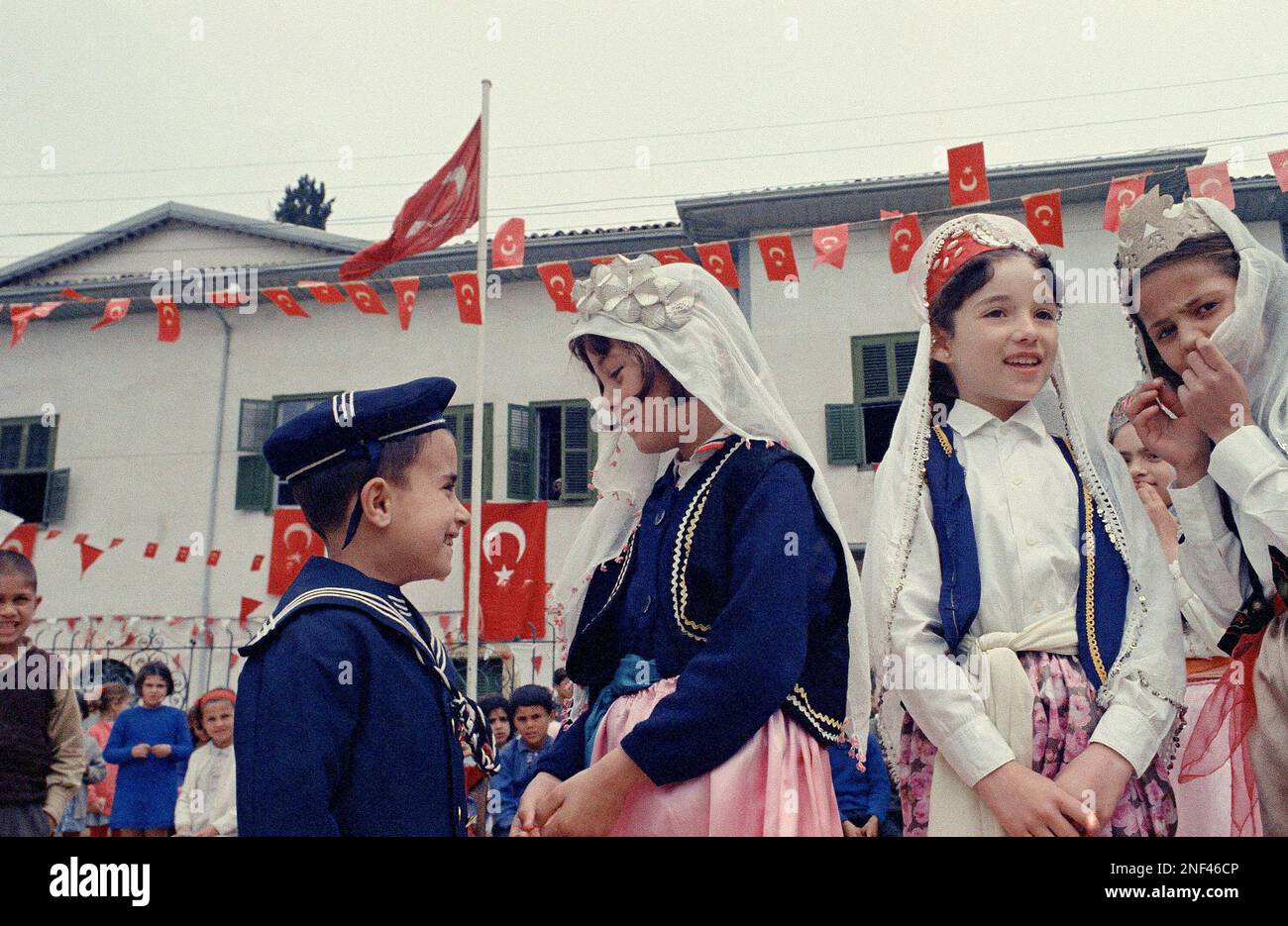 Turkish children, dressed in their national dresses, are signing and ...