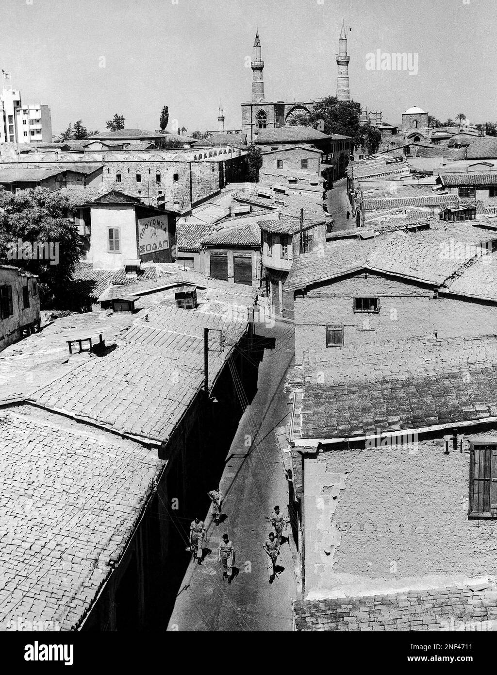 Five men of the 1st. Battalion, the Suffolk regiment, patrol a deserted ...