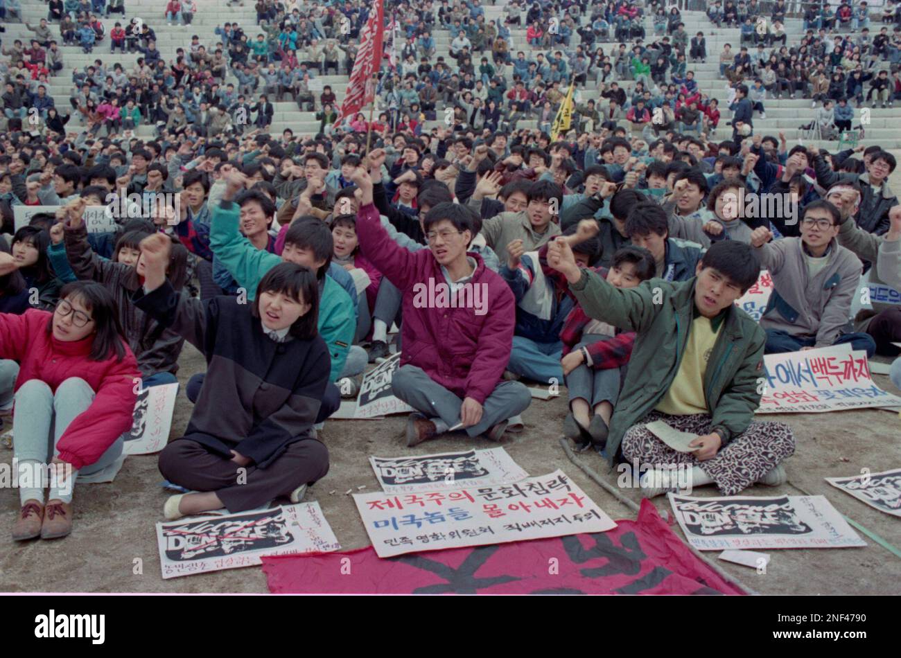 Co-ads at Dong Kuk University hold defaced portraits of U.S. President ...