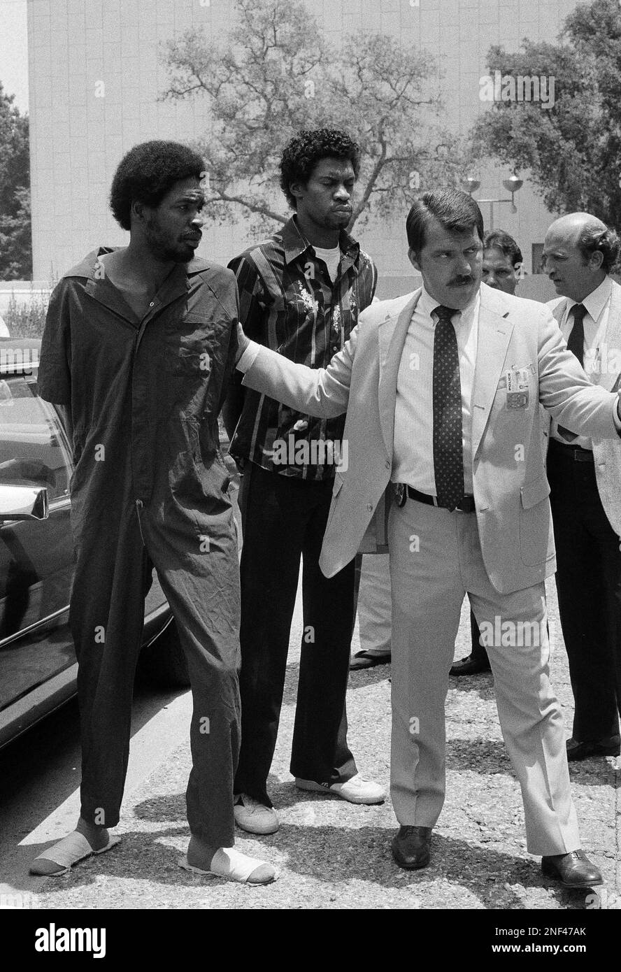 Raynard Cummings, left, is escorted by an unidentified Los Angeles ...